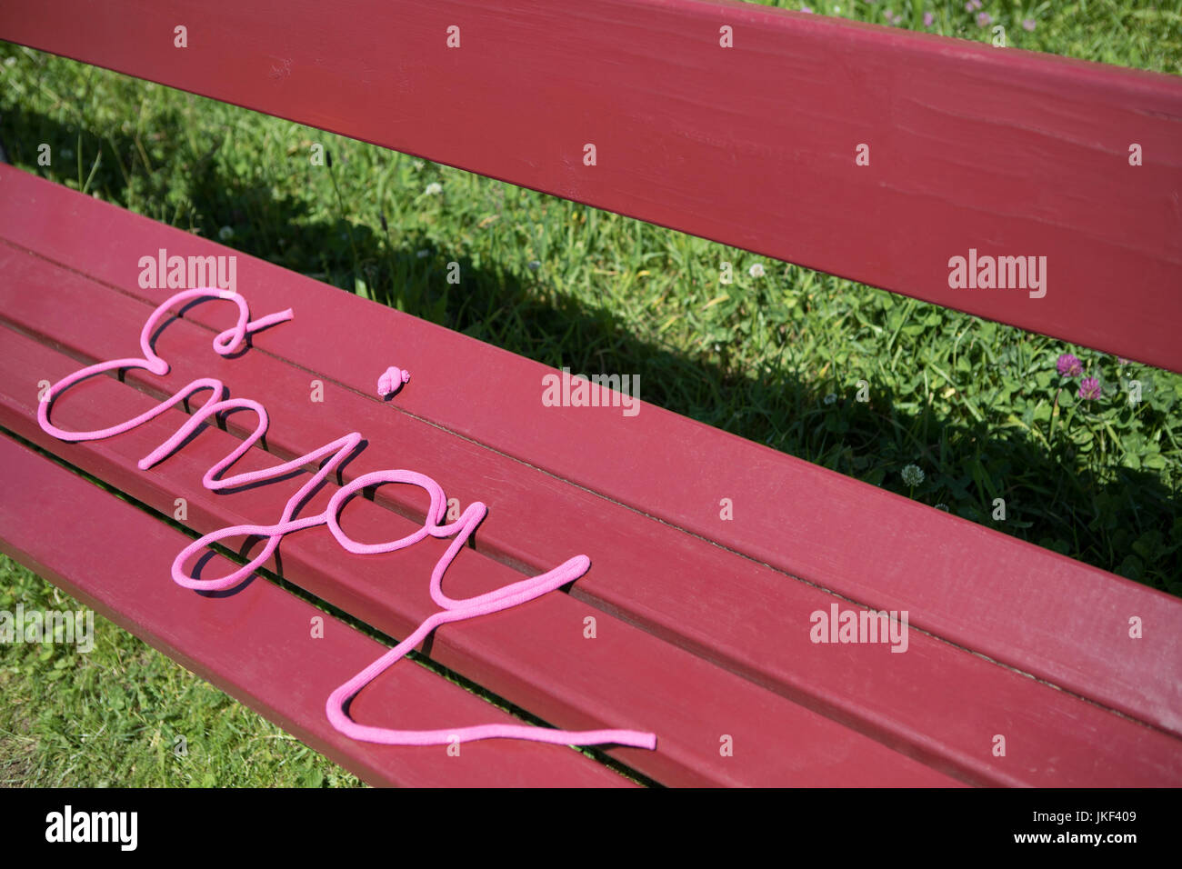 Word enjoy on a bench Stock Photo - Alamy