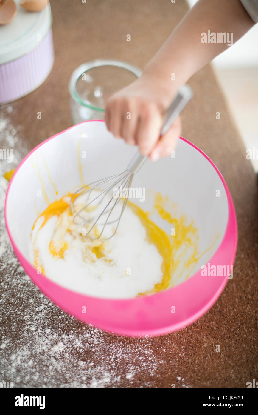 Girl's hand stirring dough Stock Photo - Alamy