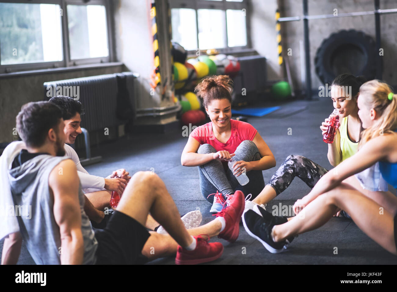 Group of young people having a break in gym Stock Photo - Alamy