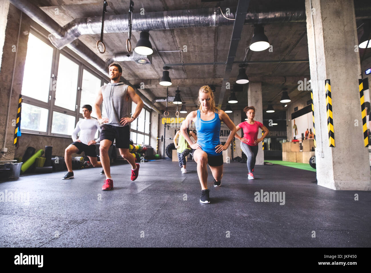 Group of young people exercising in gym Stock Photo - Alamy