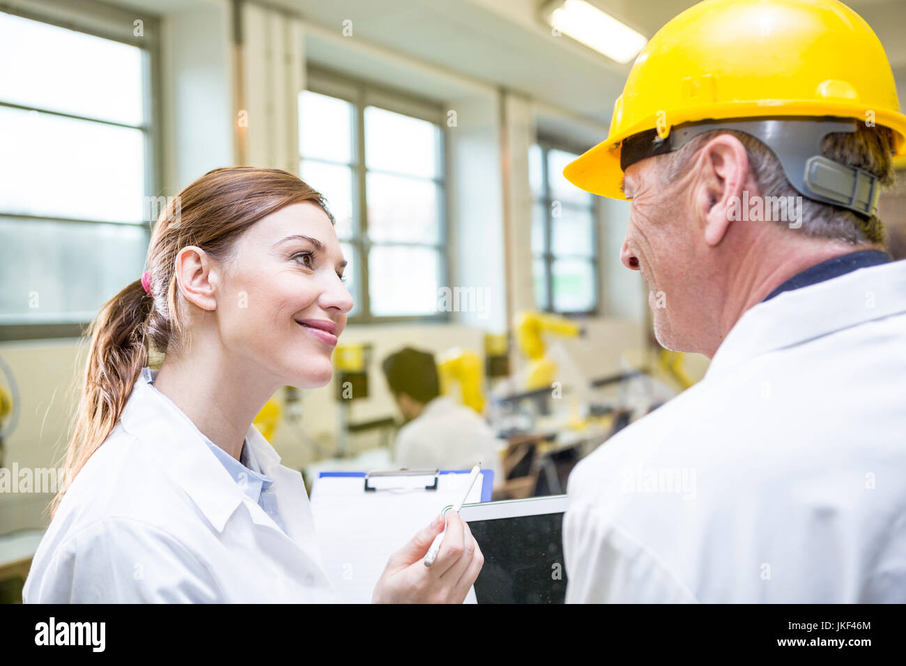 Two smiling engineers in factory Stock Photo - Alamy