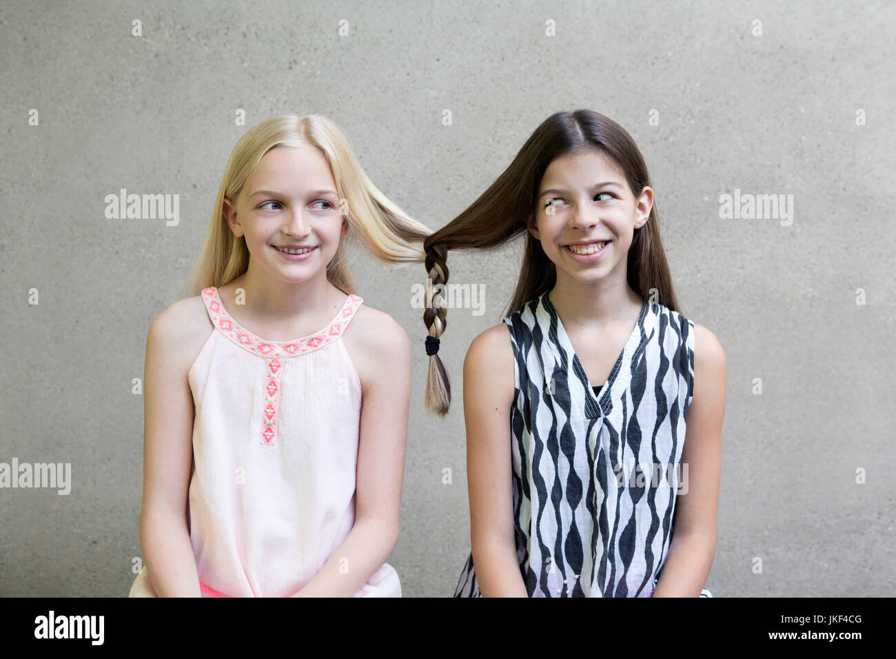 Portrait of two long-haired girls with one braid Stock Photo - Alamy