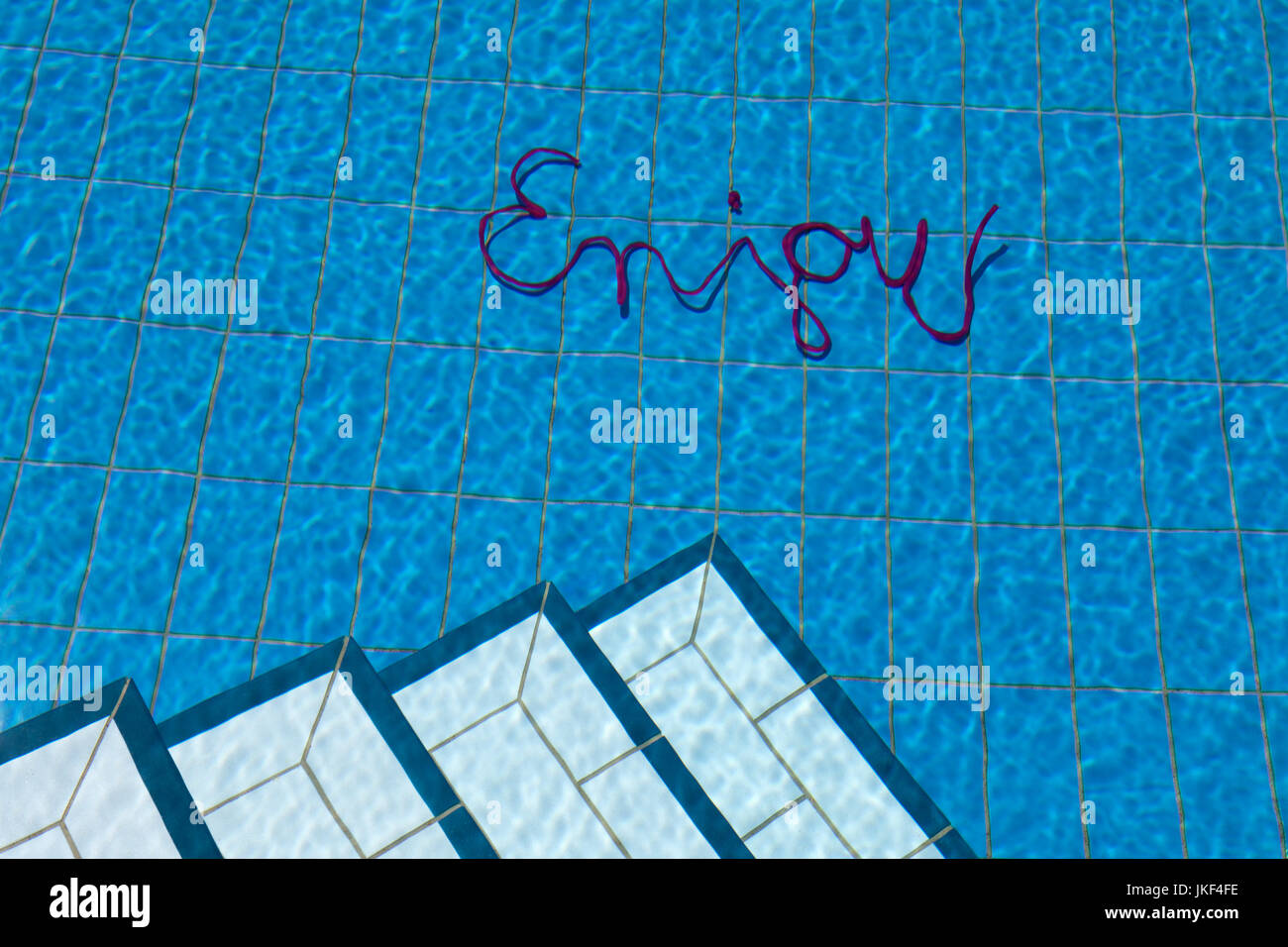 Word enjoy in water of a swimming pool Stock Photo - Alamy