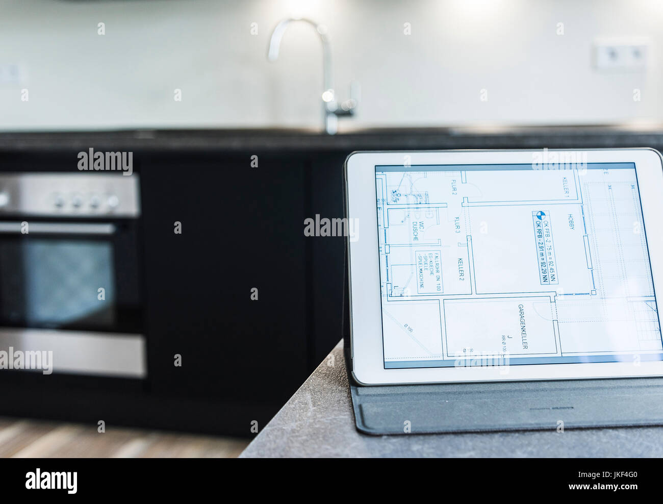 Tablet with floor plan on kitchen counter Stock Photo - Alamy