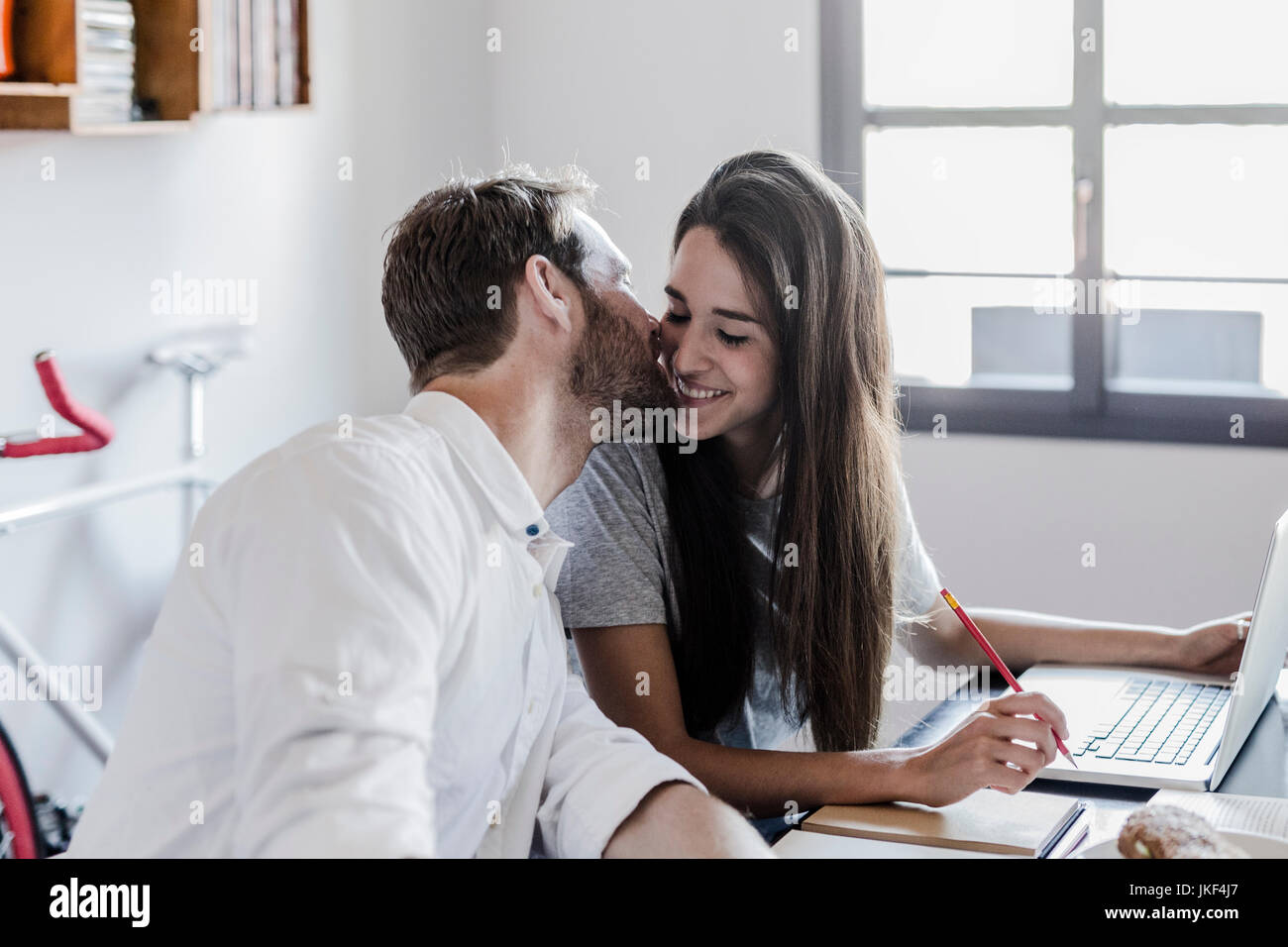 Man kissing laptop in office hi-res stock photography and images - Alamy