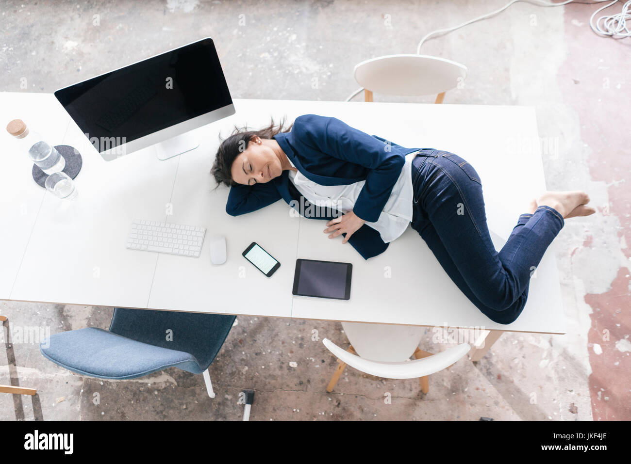 Businesswoman sleeping on desk in the office Stock Photo - Alamy