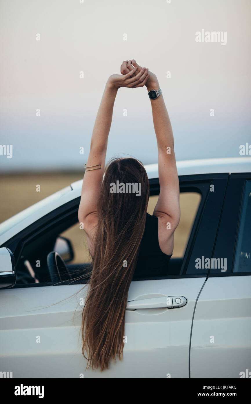 Woman leaning out of car window Stock Photo - Alamy