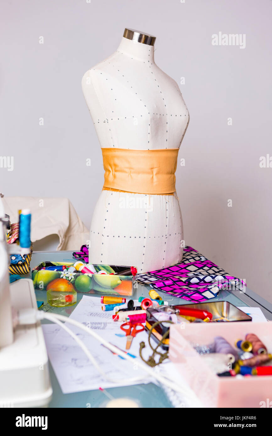 Fashion designer's working table with mannequin and equipment Stock ...