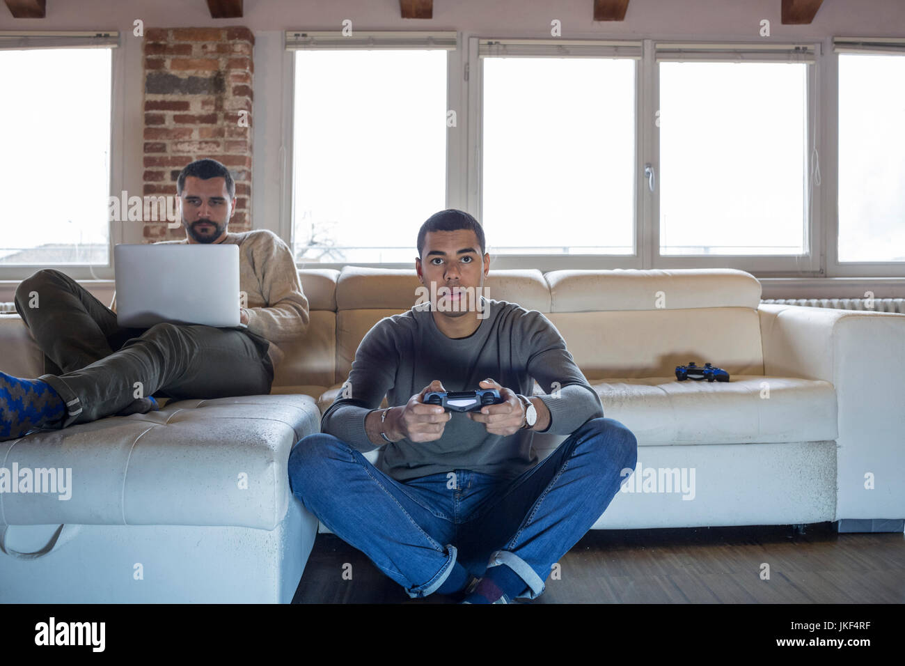 Friends playing computer game at home Stock Photo - Alamy