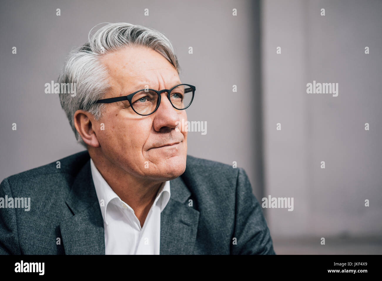 Portrait of senior businessman looking sideways Stock Photo - Alamy