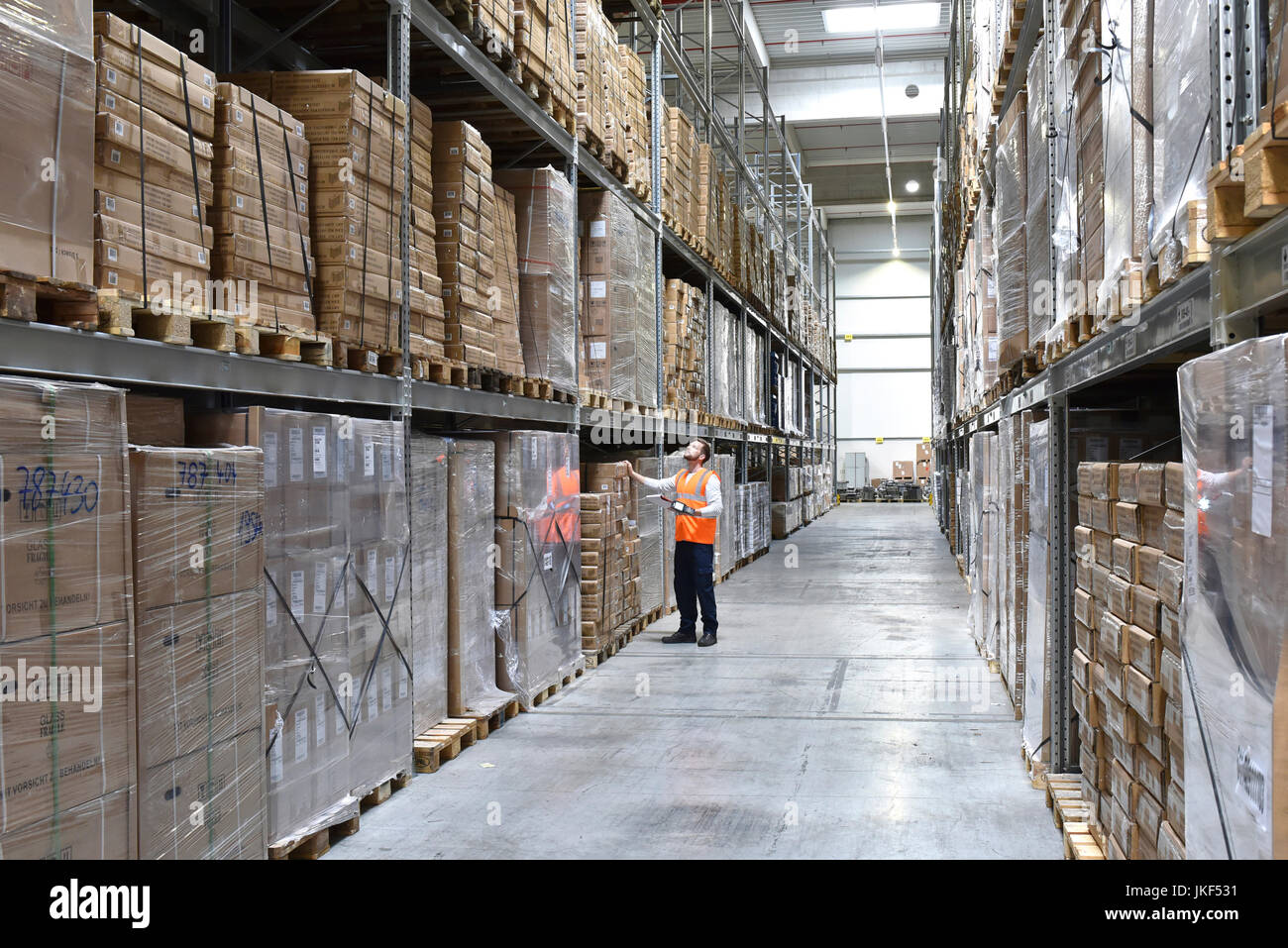 Man in factory hall wearing safety looking up Stock Photo - Alamy