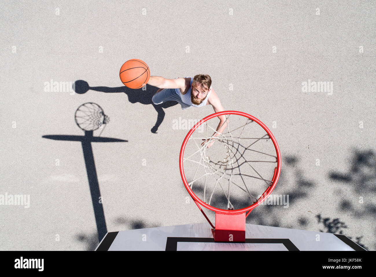 Man playing basketball on outdoor court Stock Photo - Alamy