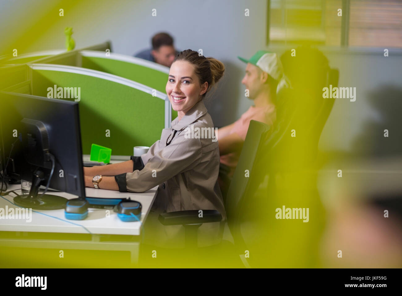 Young woman working on computer in office cubicle Stock Photo - Alamy