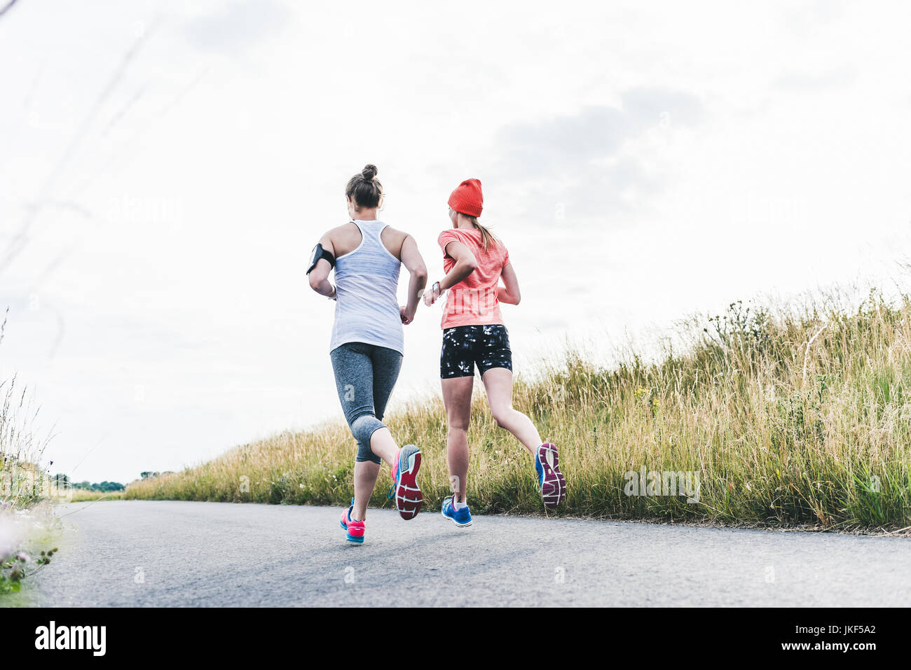 Two women running in the countryside Stock Photo - Alamy