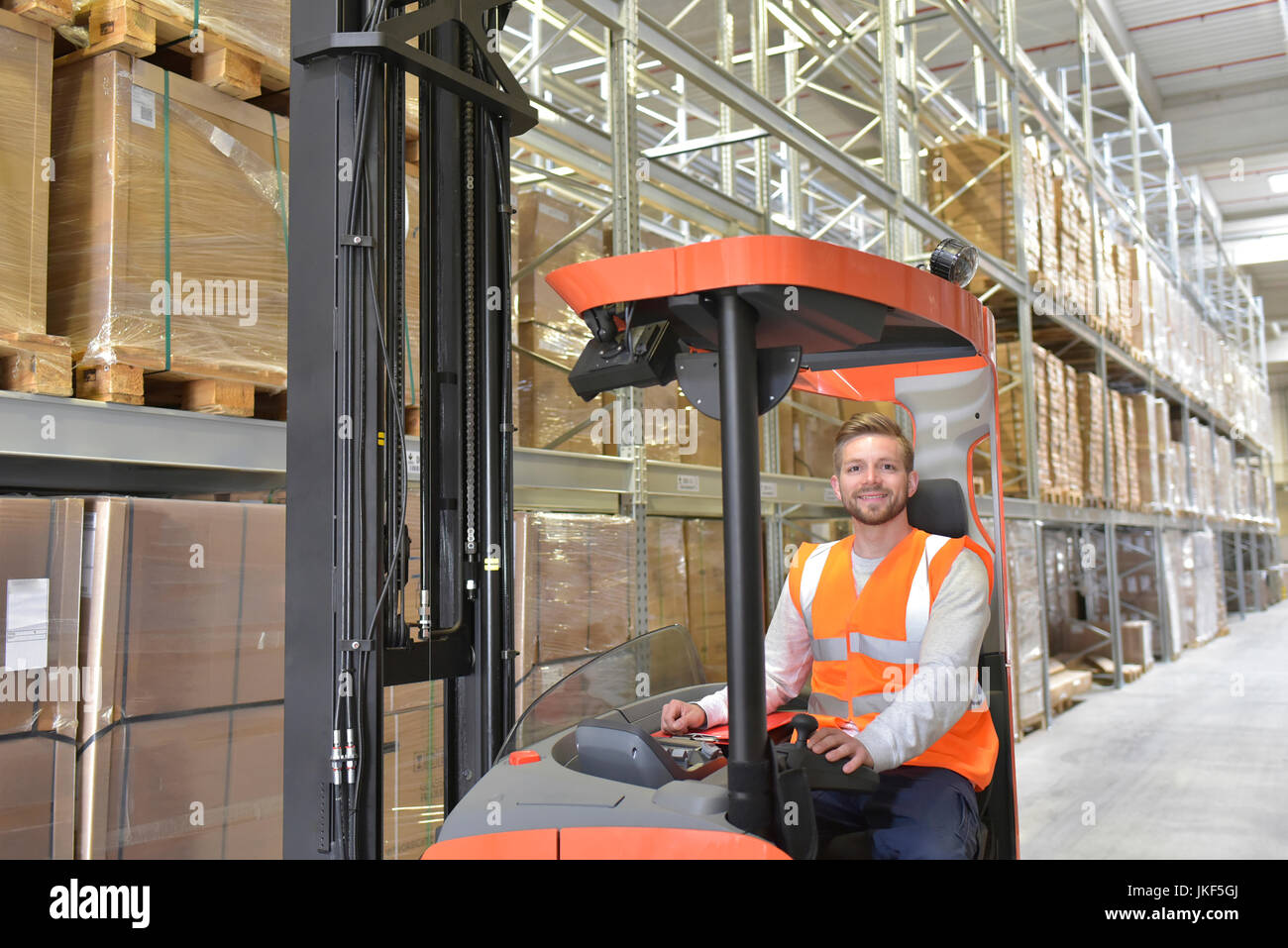 Portrait of smiling man in factory hall on forklift Stock Photo - Alamy