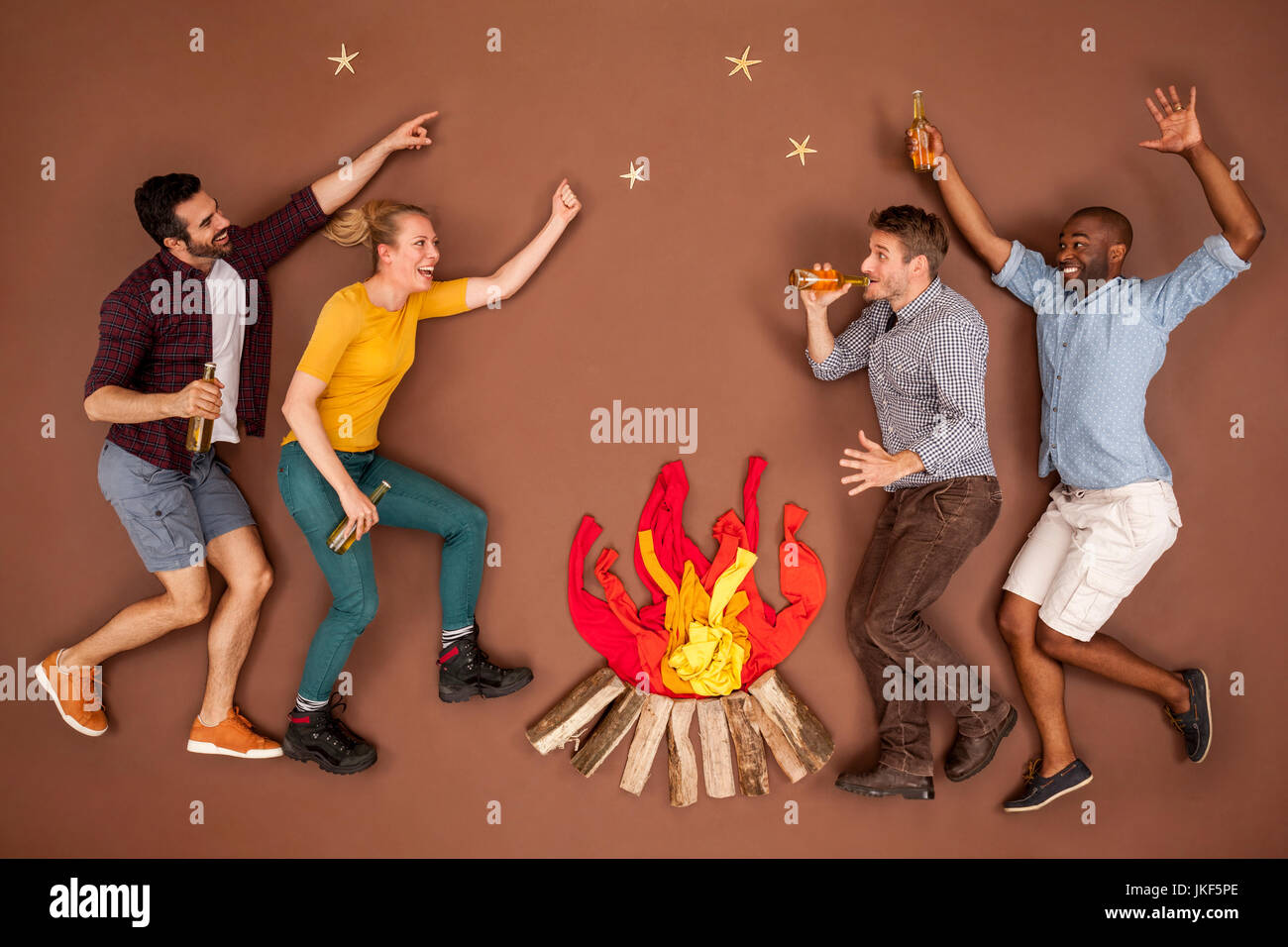 Friends at the campfire having a party Stock Photo - Alamy