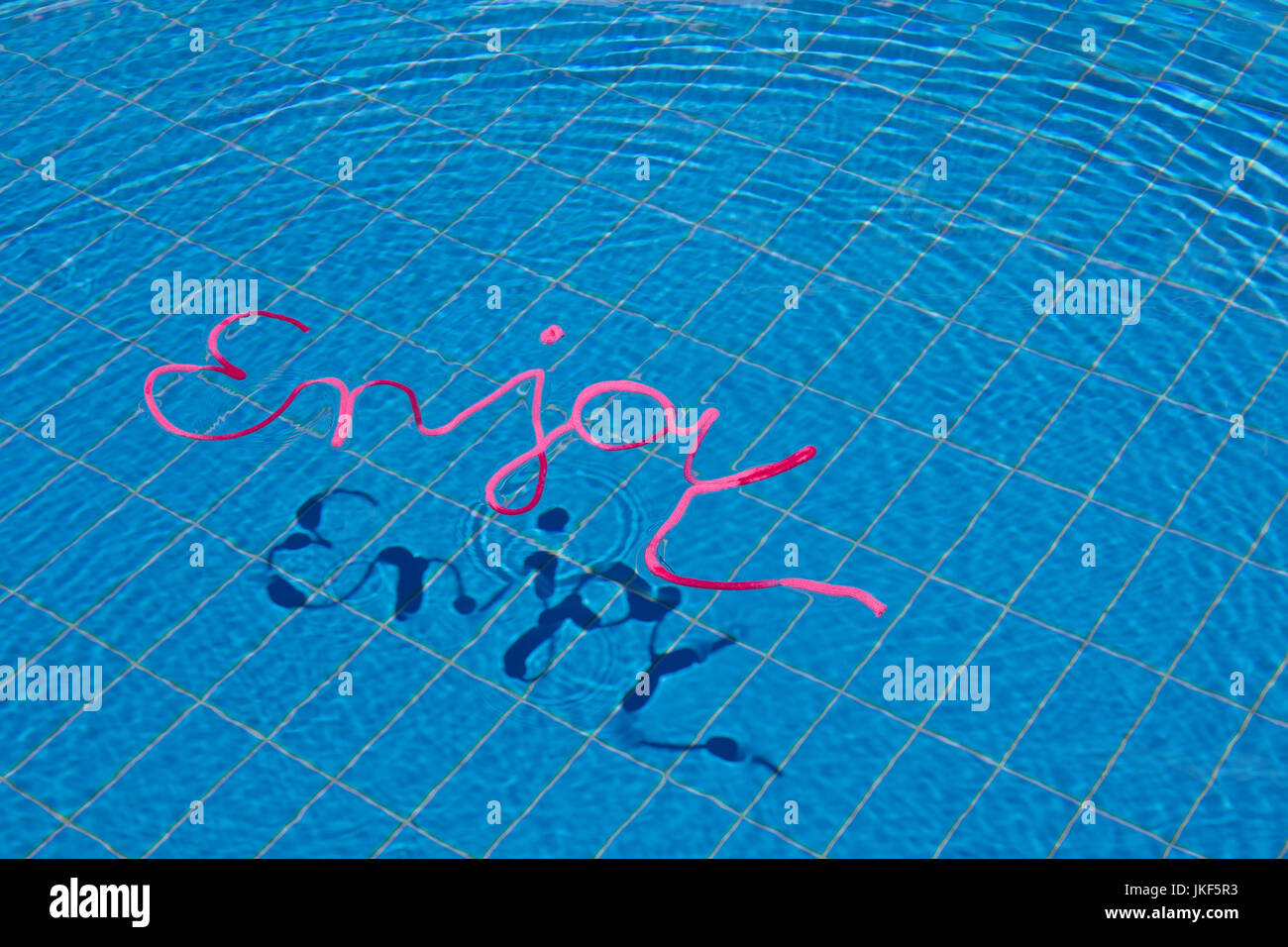 Word enjoy in water of a swimming pool Stock Photo - Alamy