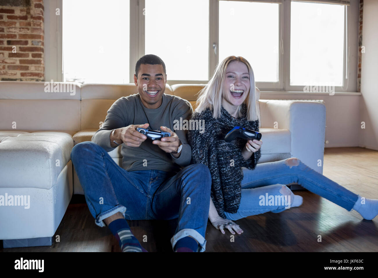 Two friends playing computer game at home Stock Photo - Alamy