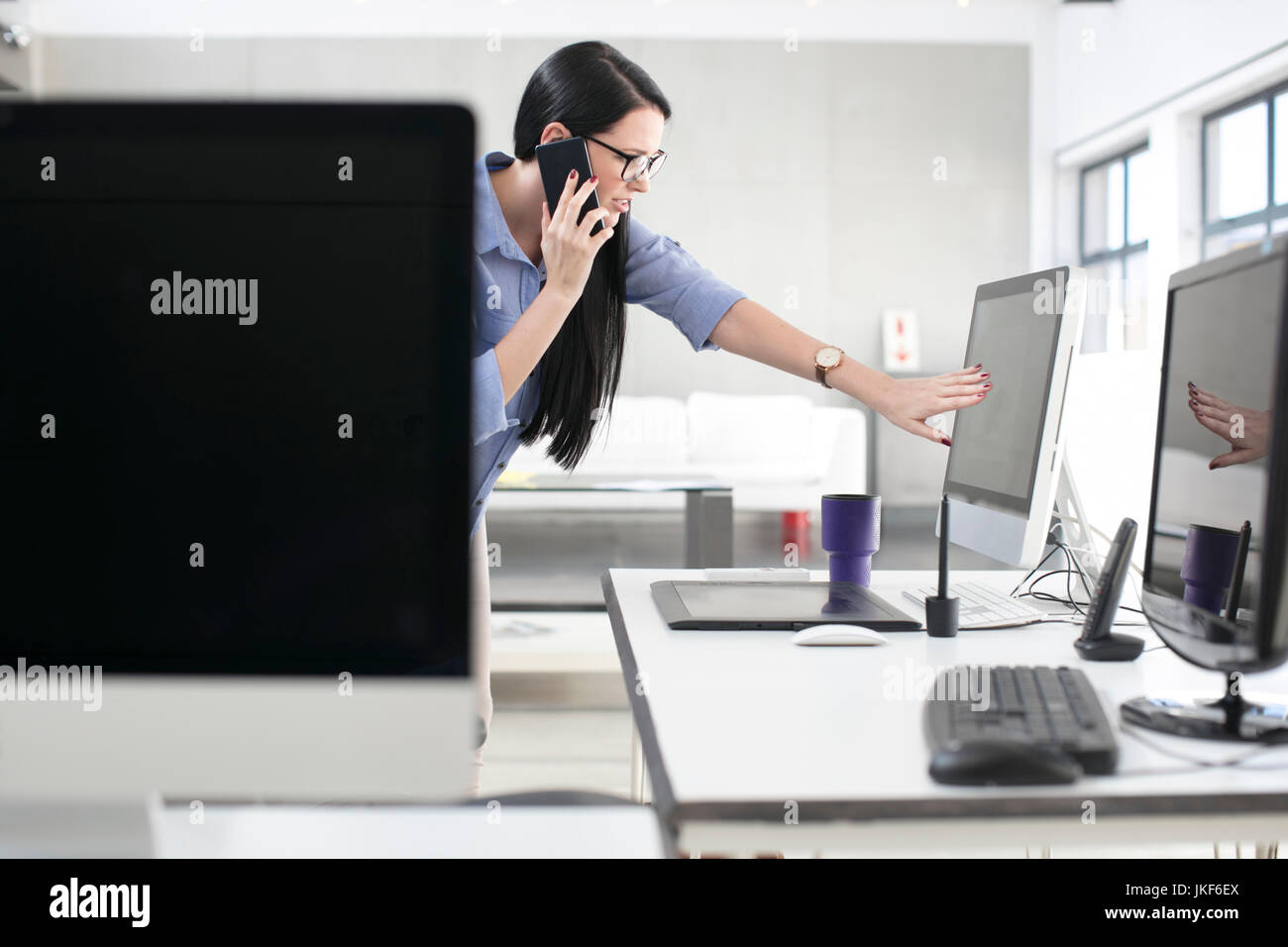 Employee at desk on the phone Stock Photo - Alamy
