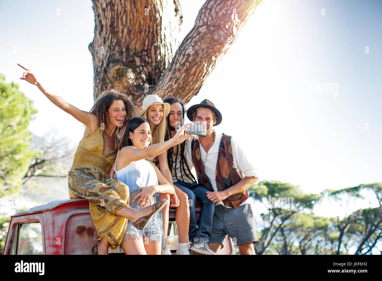 Happy young people outside pick up truck taking a selfie Stock Photo ...