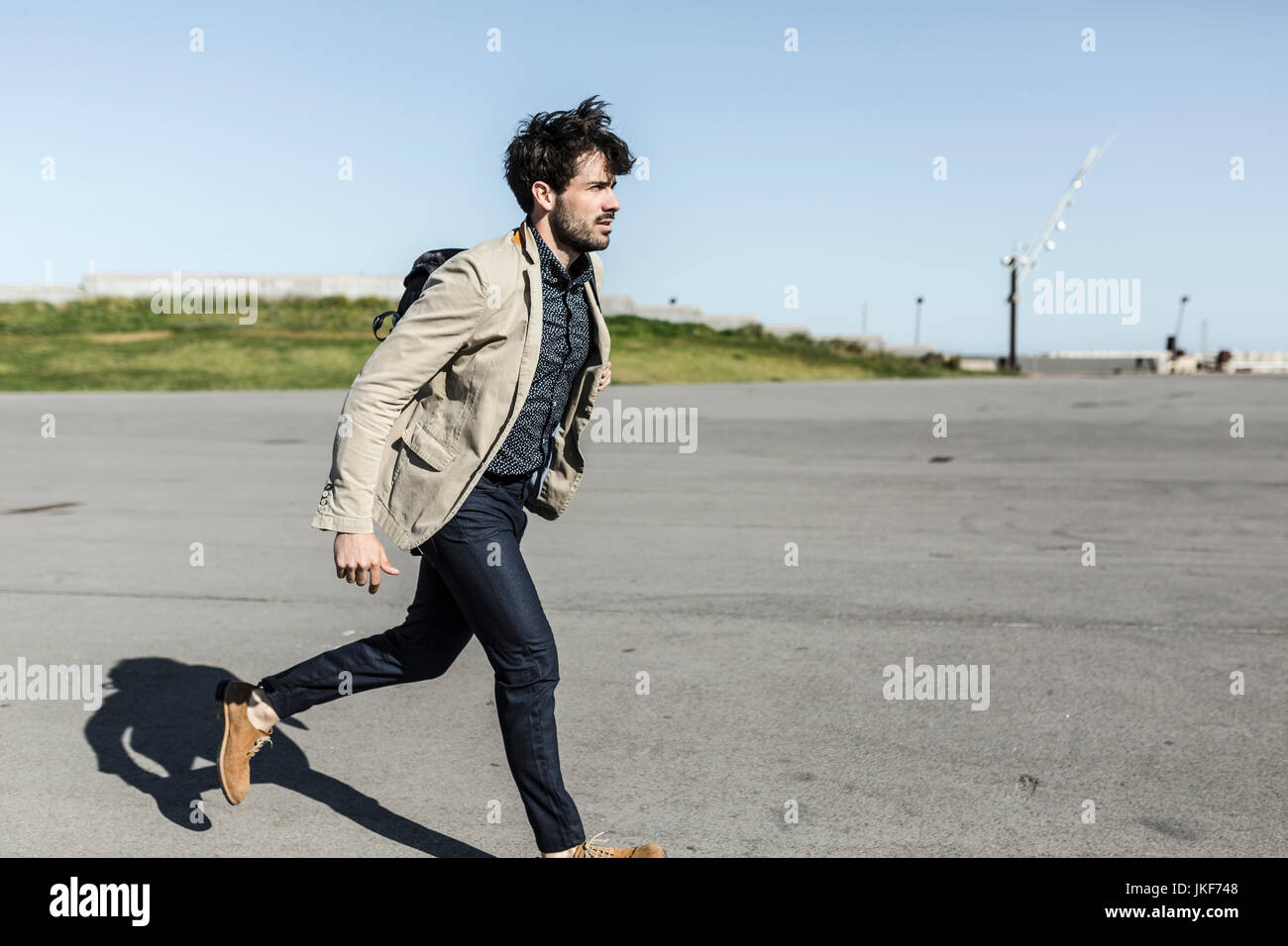 Running man with backpack outdoors Stock Photo - Alamy