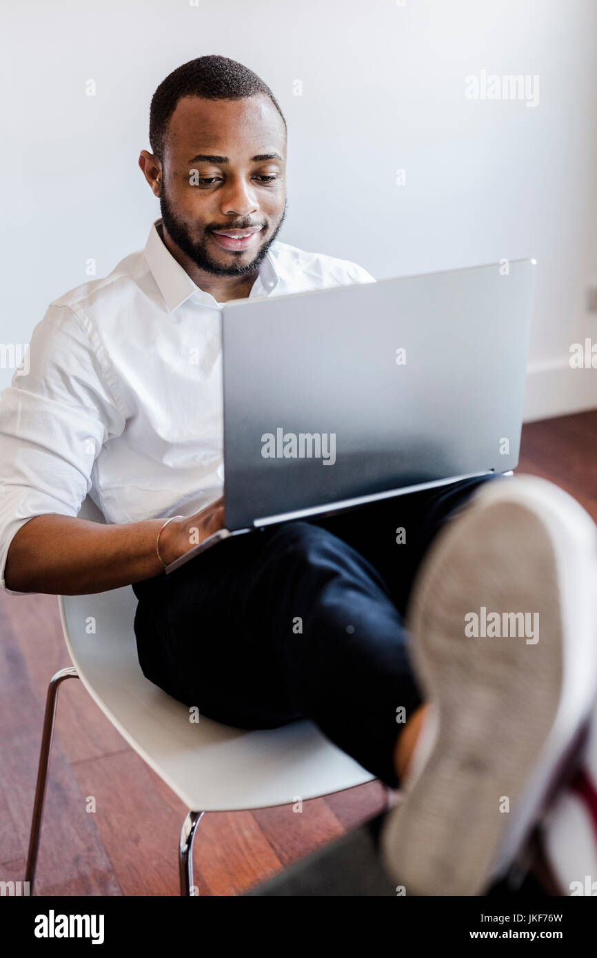 Feet on desk in front of man hi-res stock photography and images - Alamy