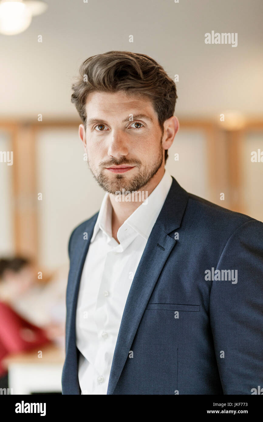 Portrait of serious businessman in office Stock Photo - Alamy