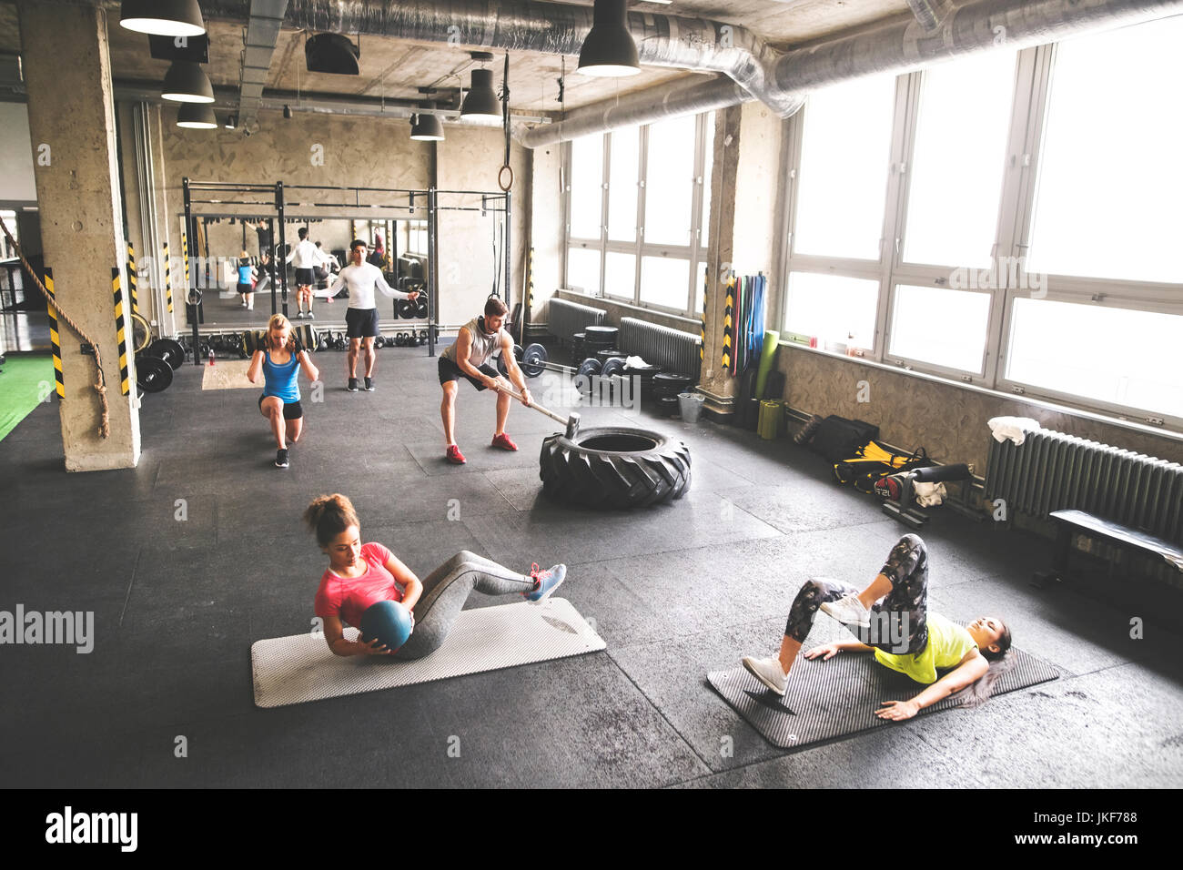 Group of young people exercising in gym Stock Photo - Alamy