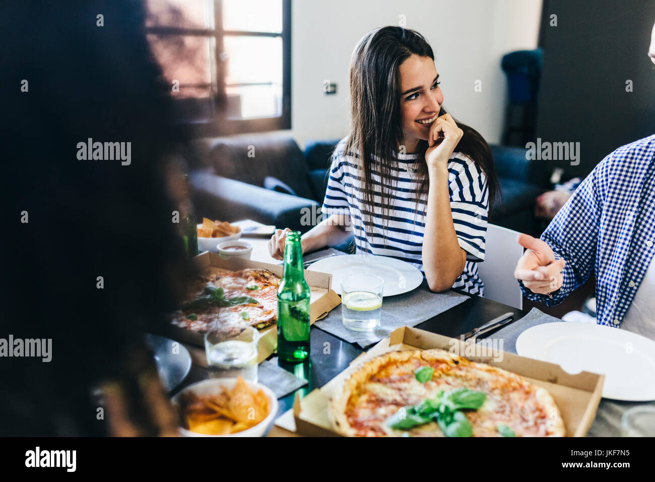 Friends having a pizza at home Stock Photo - Alamy