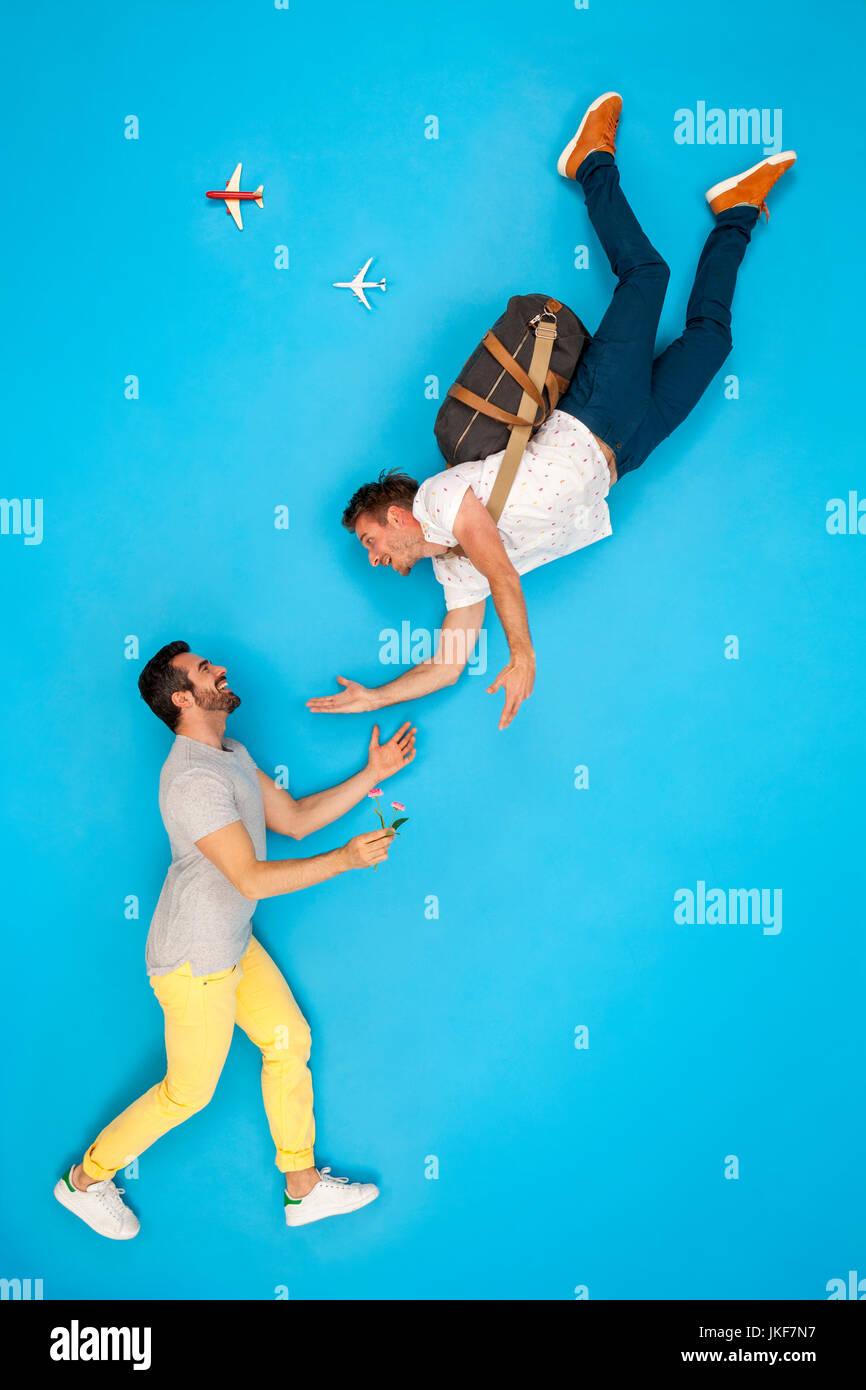 Gay couple reuniting after one coming back from journey Stock Photo - Alamy