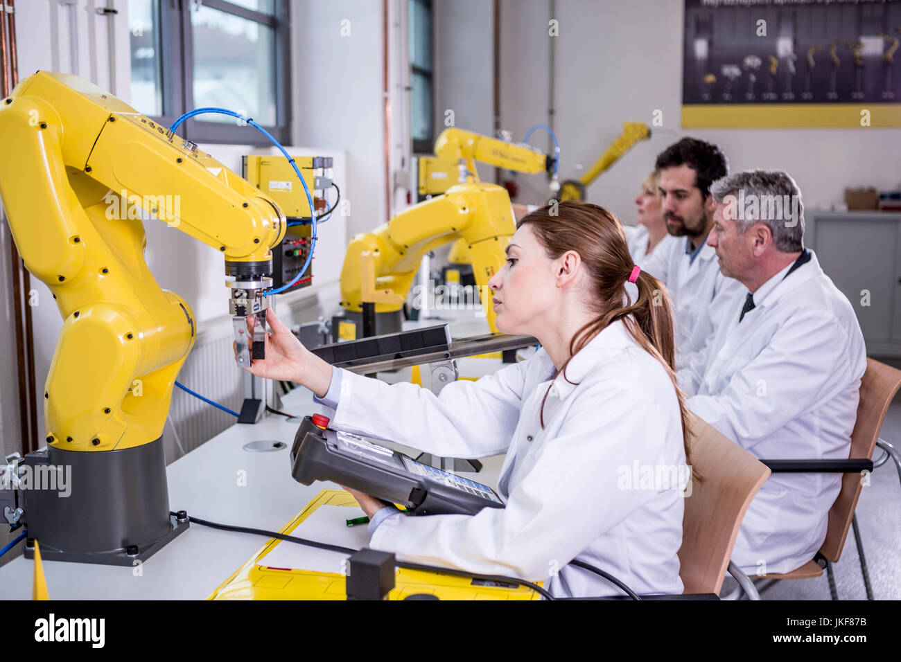 Engineers examining industrial robots Stock Photo - Alamy