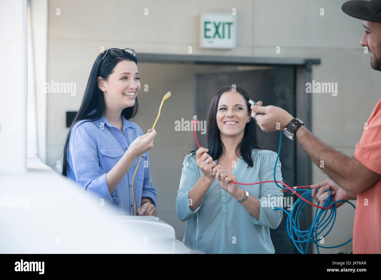 Staff members holding cables Stock Photo - Alamy
