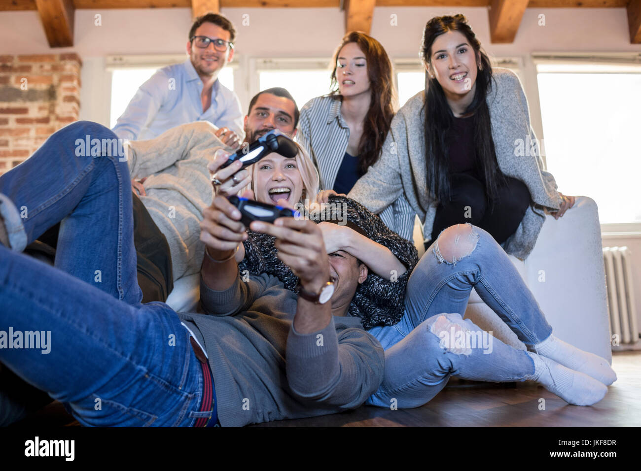 Friends playing computer game at home Stock Photo - Alamy