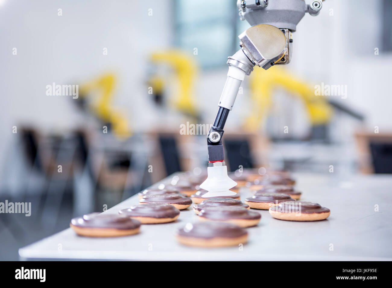 Close-up of industrial robot handling cookies Stock Photo - Alamy