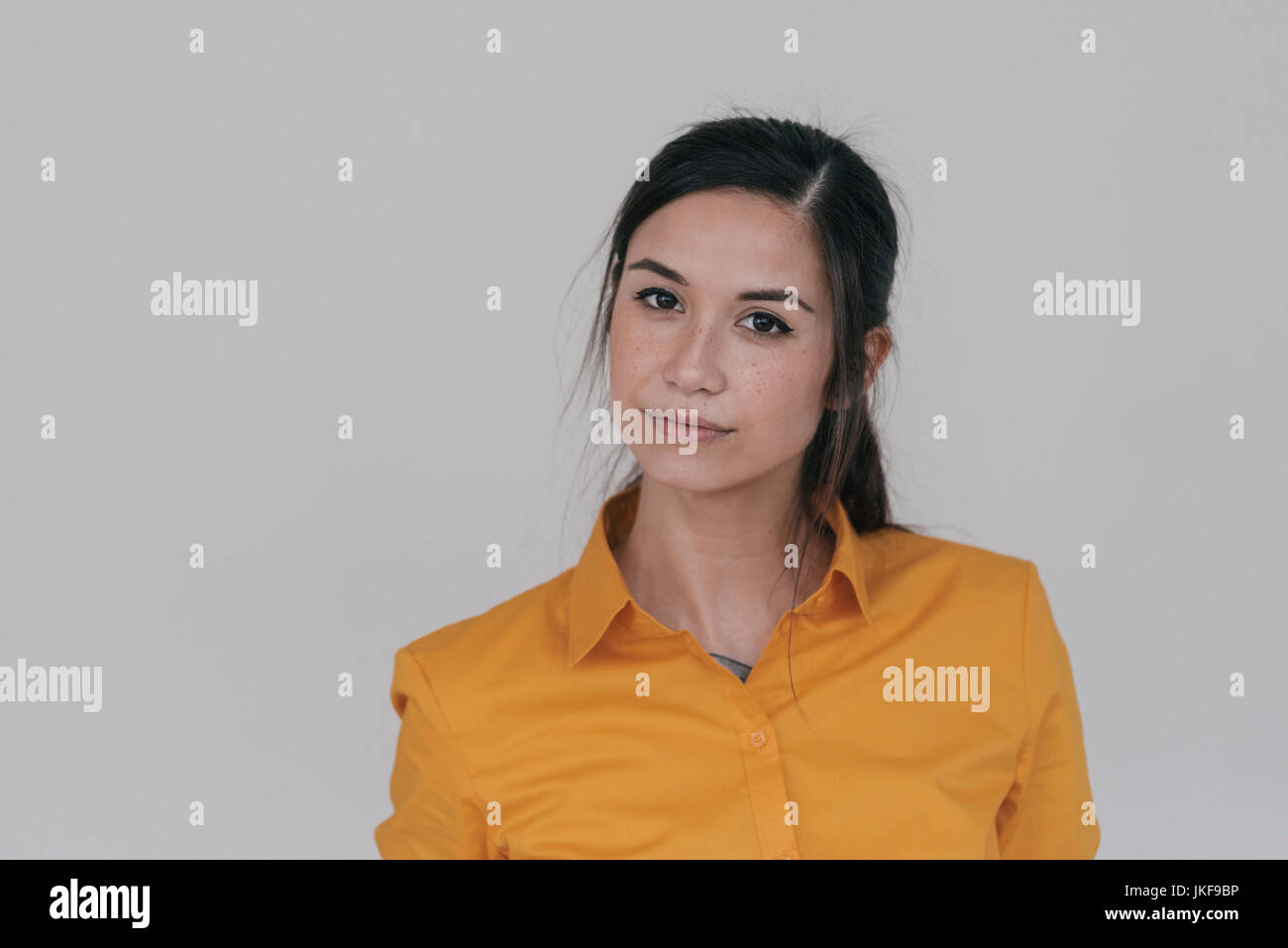 Young woman looking sceptical hi-res stock photography and images - Alamy