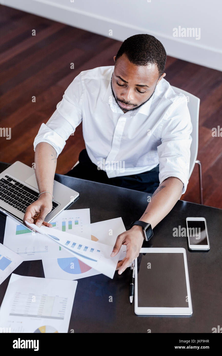 Man analysing data at desk in home office Stock Photo - Alamy