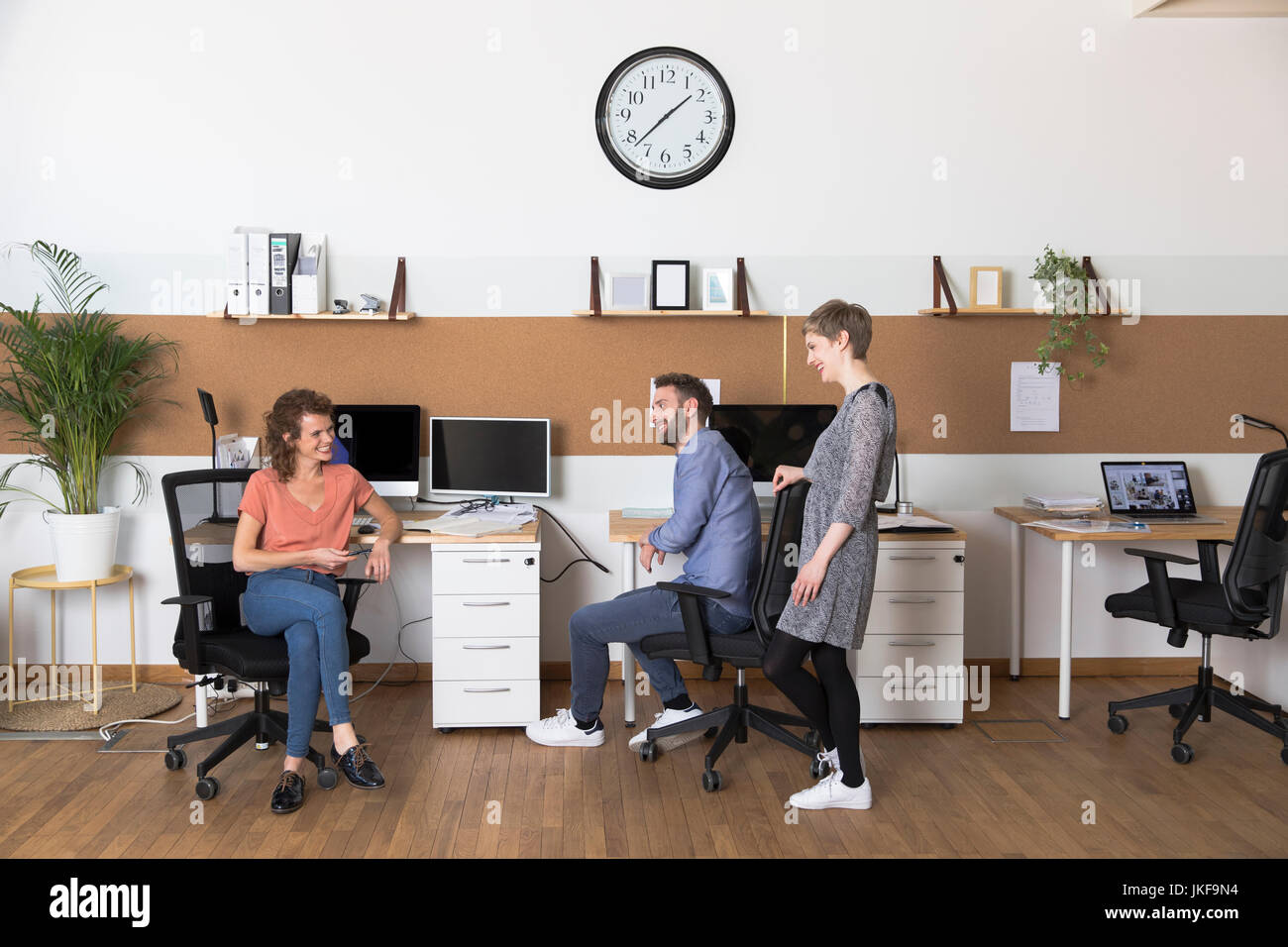 Smiling colleagues in modern office Stock Photo - Alamy