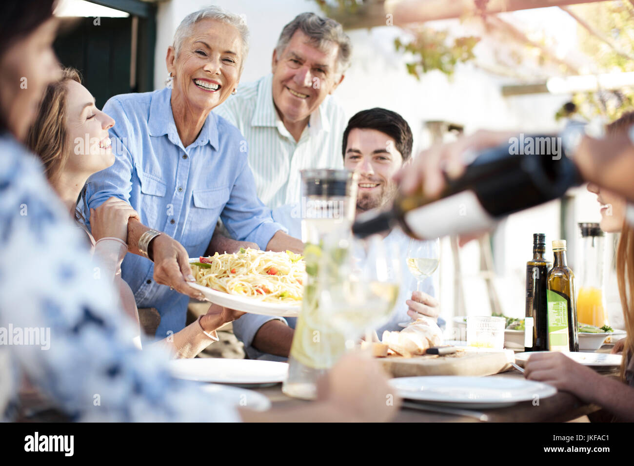Family lunch outside generations table hi-res stock photography and ...