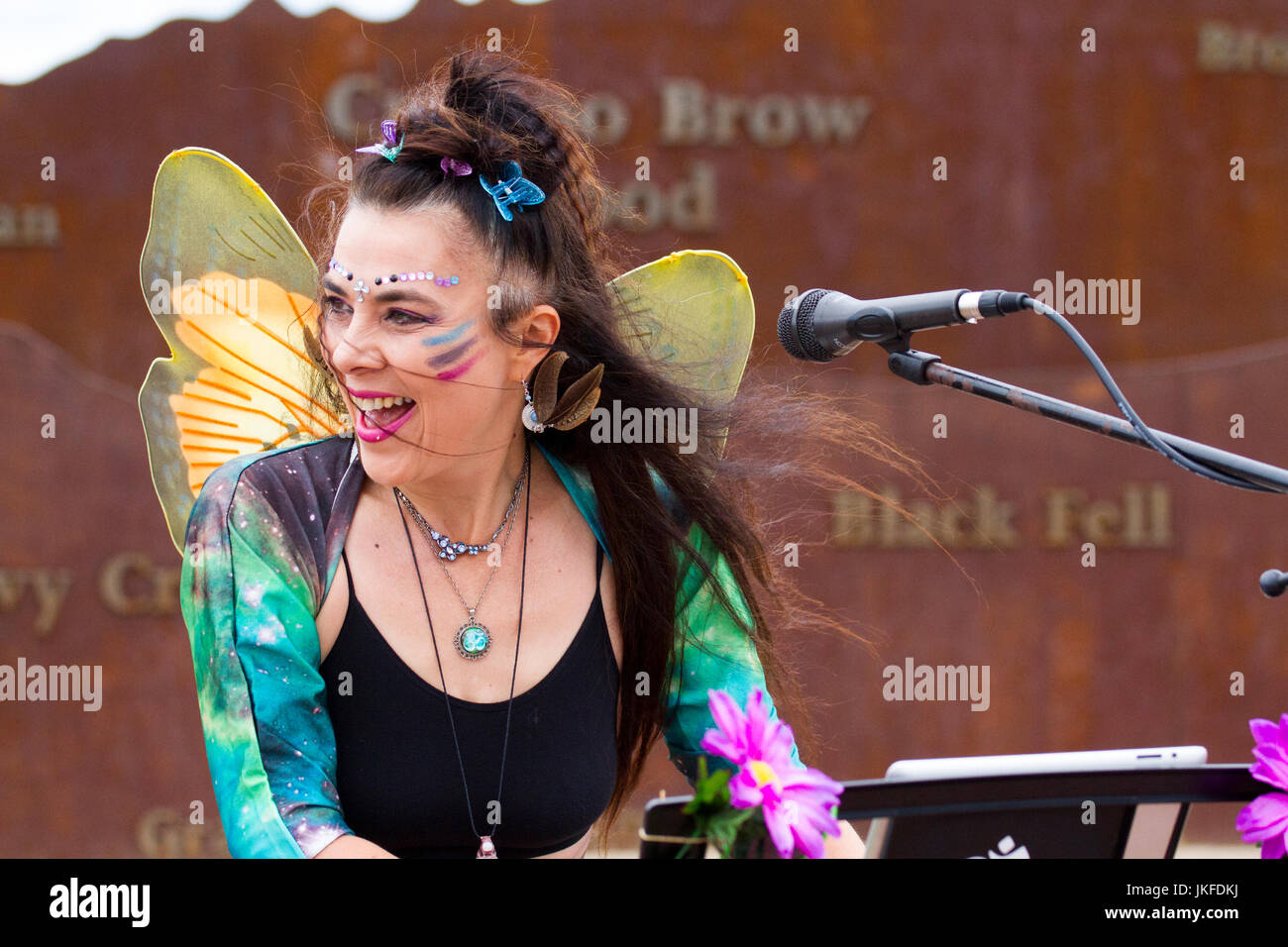Serenity Sam of Cosmic Chords, singing with Microphone. Multi ...