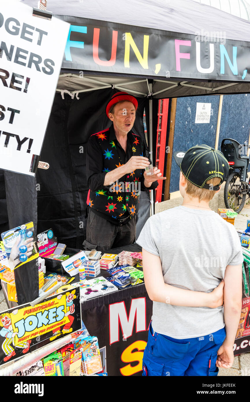 Open market stall with magic tricks on. Zenea, male local magician ...