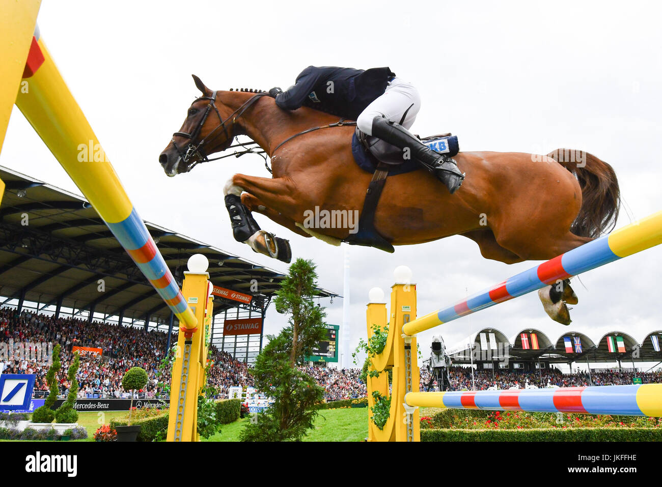 German show jumper Andreas Kreuzer jumping over an obstacle on his ...