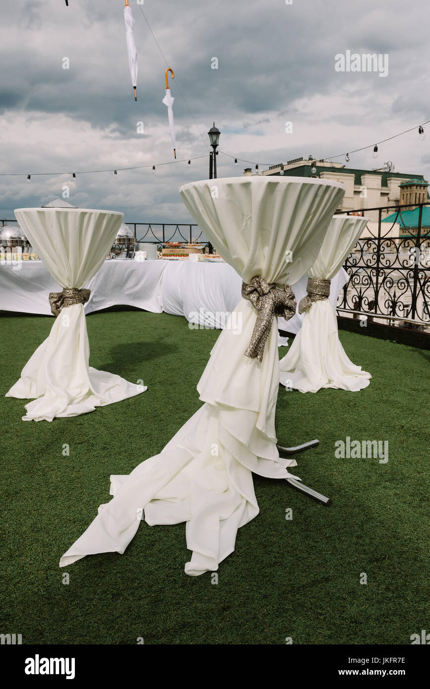 Empty decorated tables with bow knots for the wedding ceremony on the ...