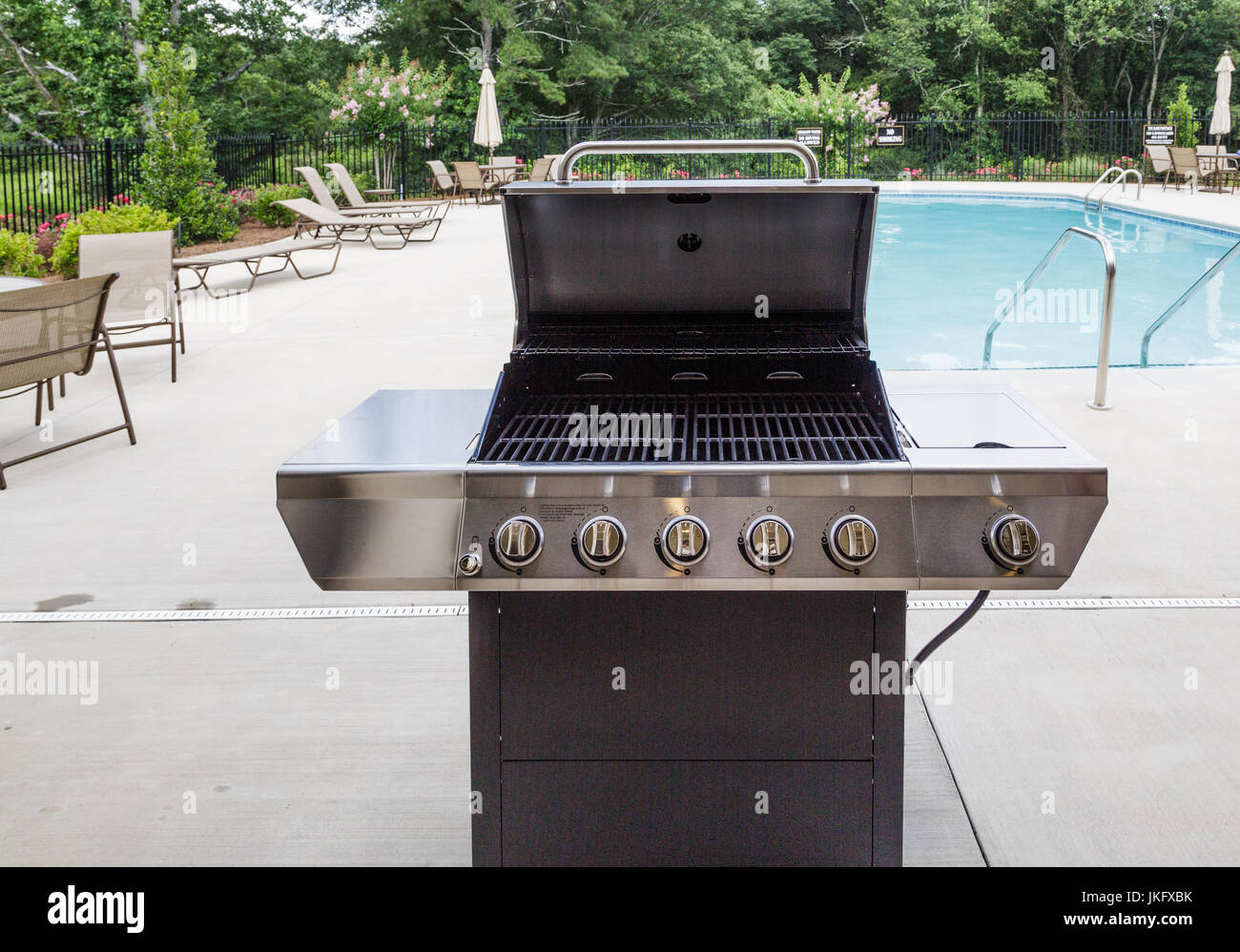 New Gas Grill by Swimming Pool on Patio Stock Photo - Alamy