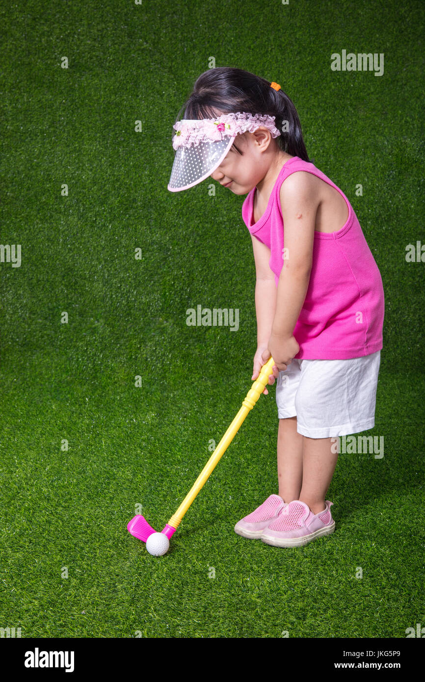 Asian Chinese little girl playing golf on green grass Stock Photo - Alamy