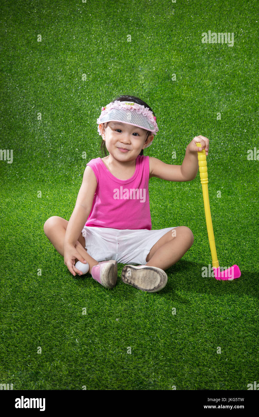 Asian Chinese little girl playing golf on green grass Stock Photo - Alamy