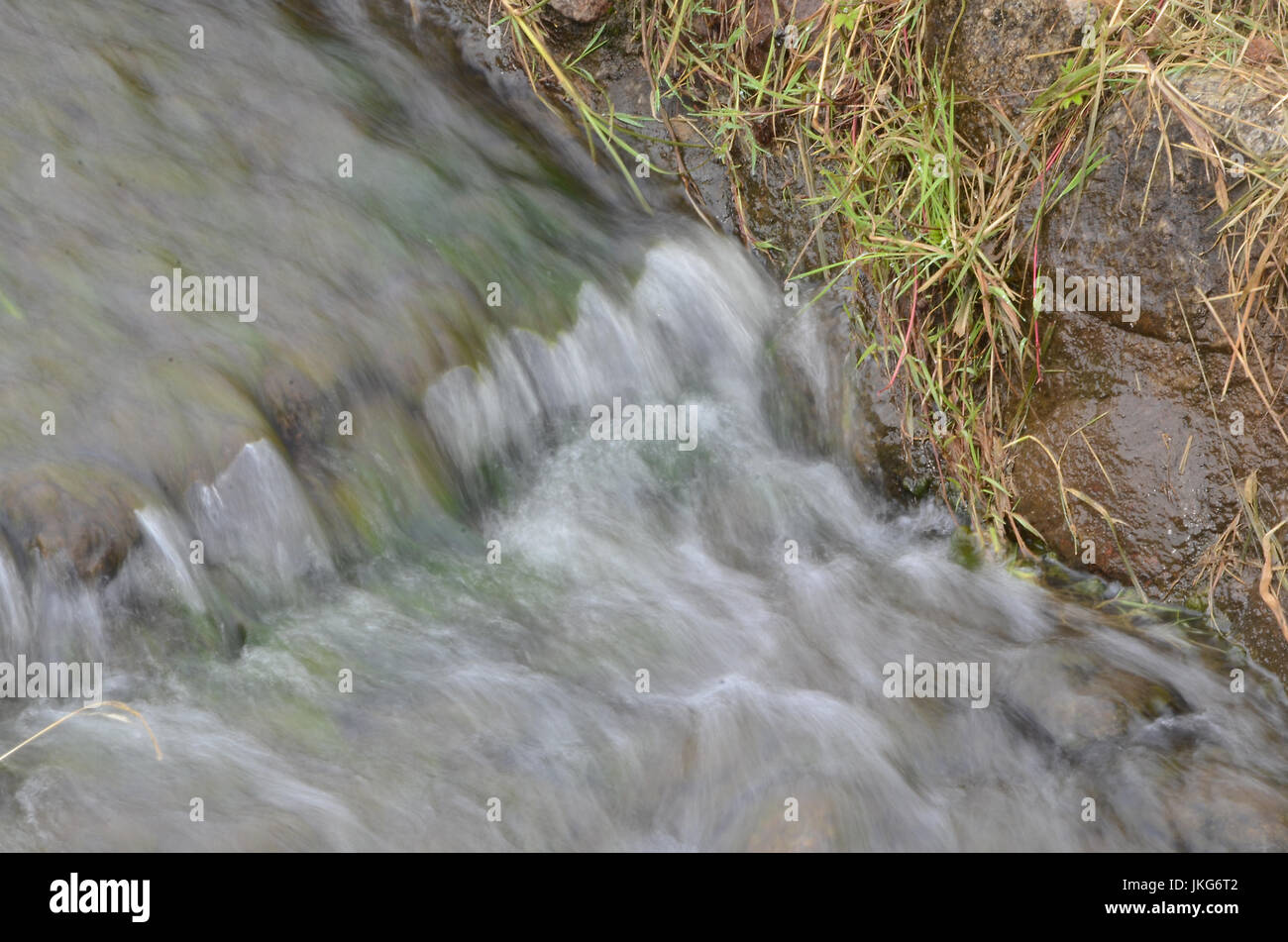 Water runs smoothly over an obstacle Stock Photo - Alamy