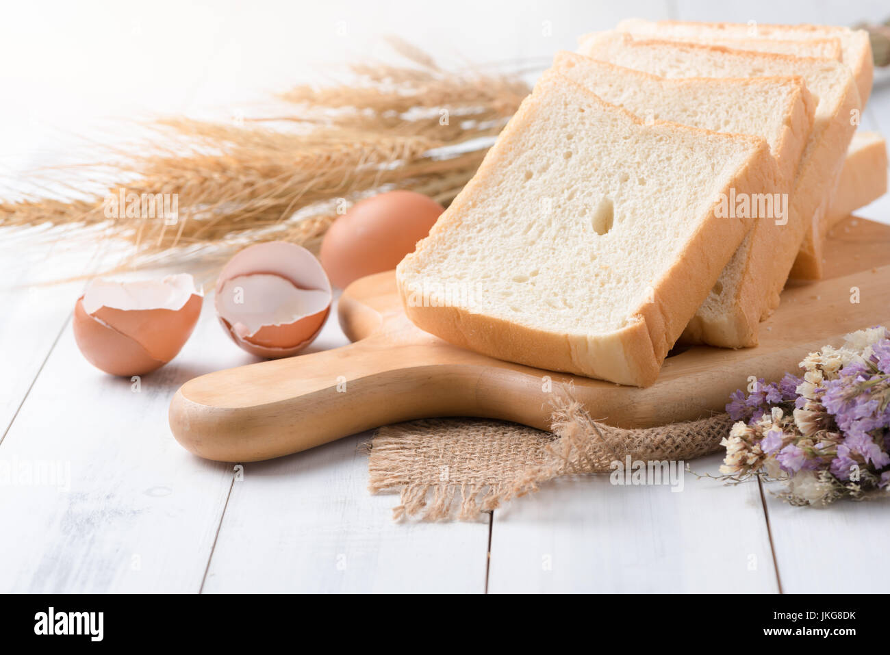 white sliced bread on wood block and white wood background Stock Photo ...