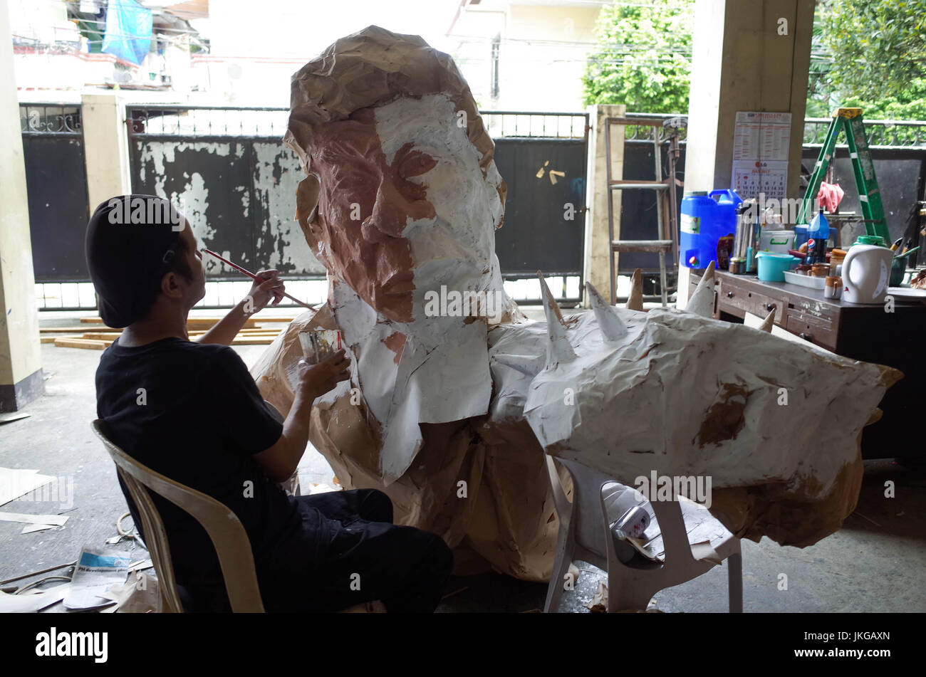 Philippines. 23rd July, 2017. Artist Max Santiago paints a part of an ...