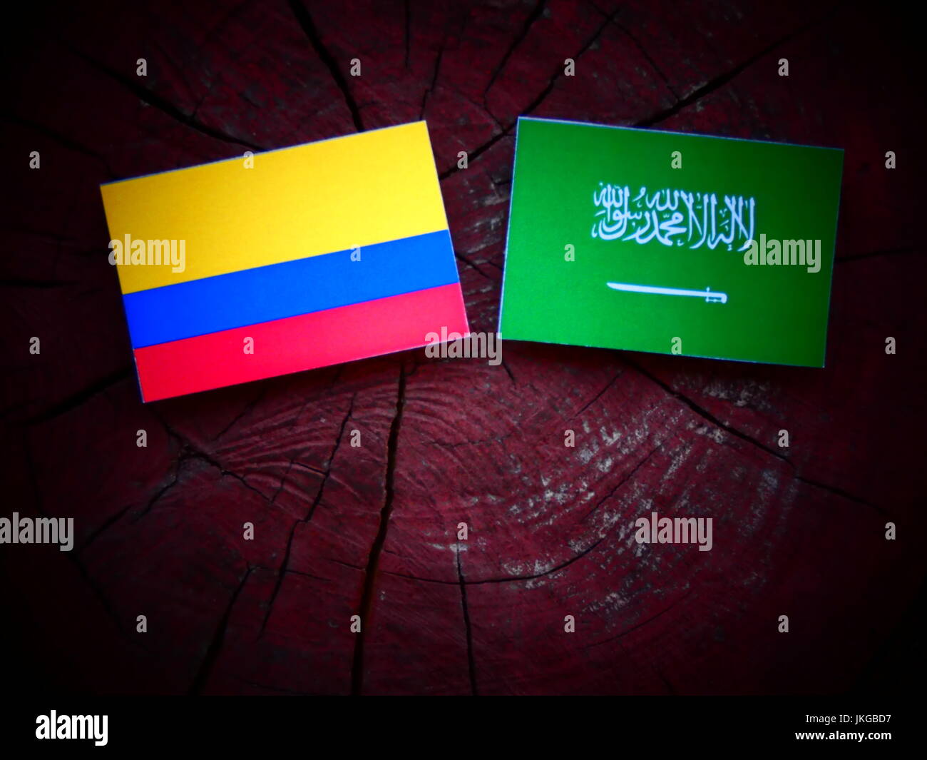 Colombian flag with Saudi Arabian flag on a tree stump isolated Stock ...