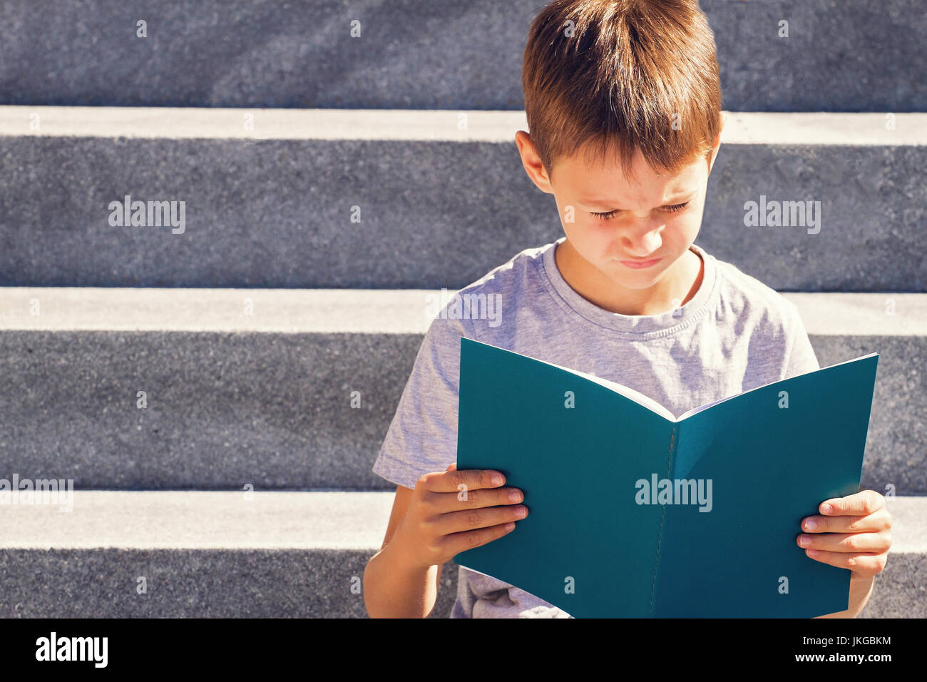 Schoolboy reading books. Kid doing homework outdoors. Back to school ...